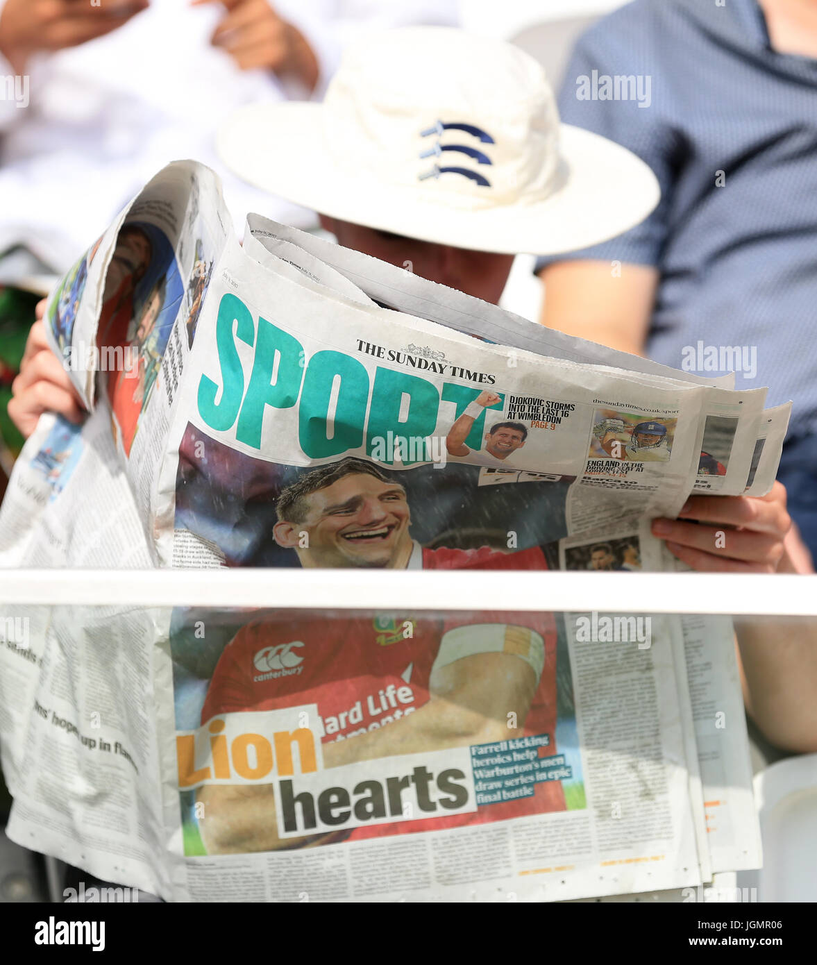 A spectator reading the Sunday papers before day four of the First ...