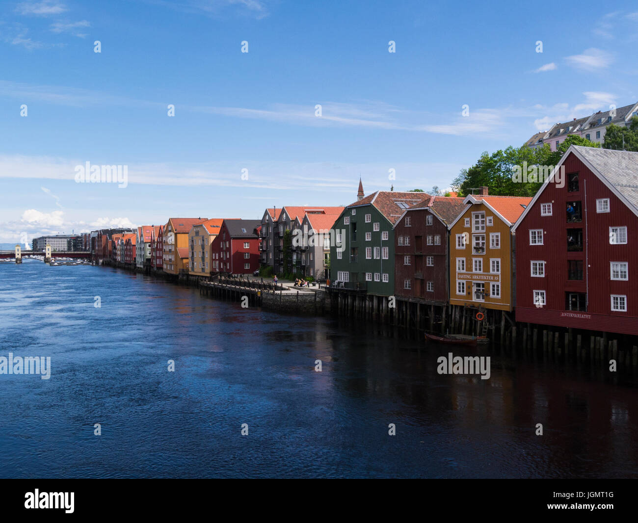 View along River Nidelva flanked by well maintained colourful buildings ...