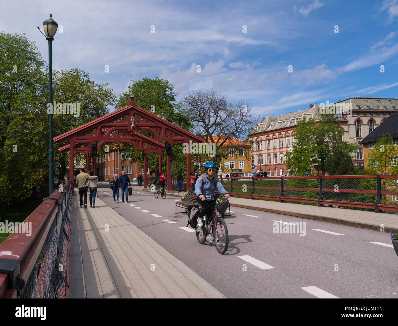 Women cyclist and tourists on Gamle Bybro Old Town Bridge Trondheim ...