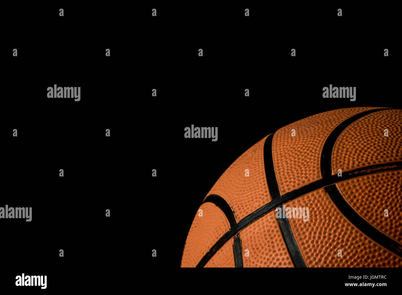 A single basketball isolated on a black background Stock Photo - Alamy