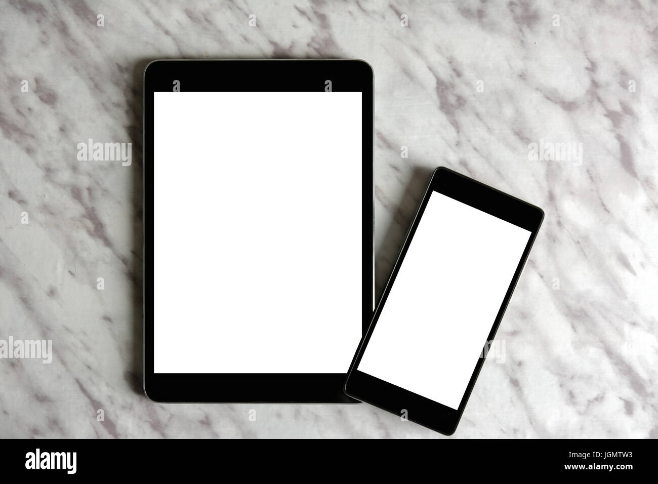 Empty generic tablet pc and mobile on top of white marble, vertical ...