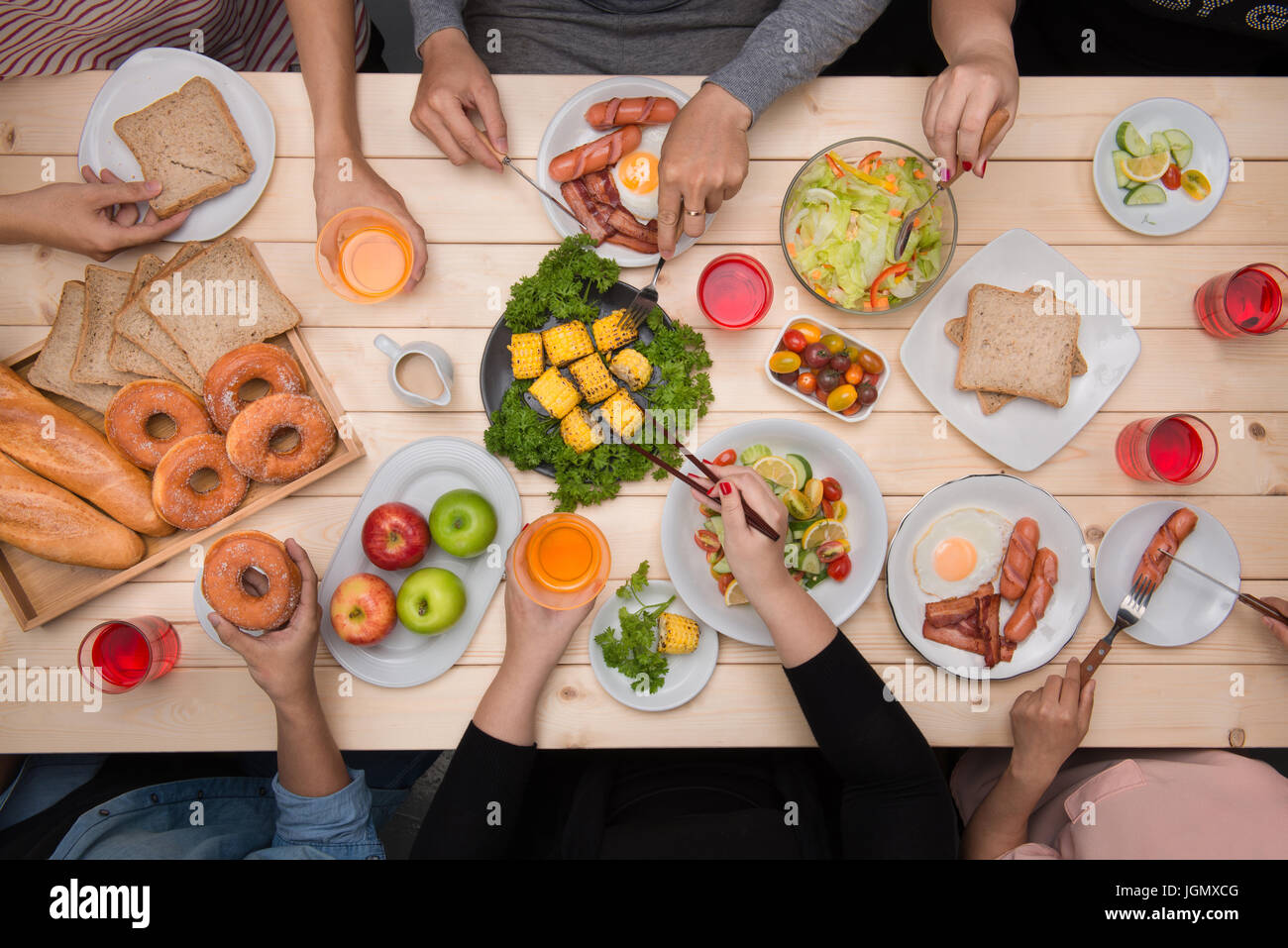 Enjoying dinner with friends. Top view of group of people having dinner ...