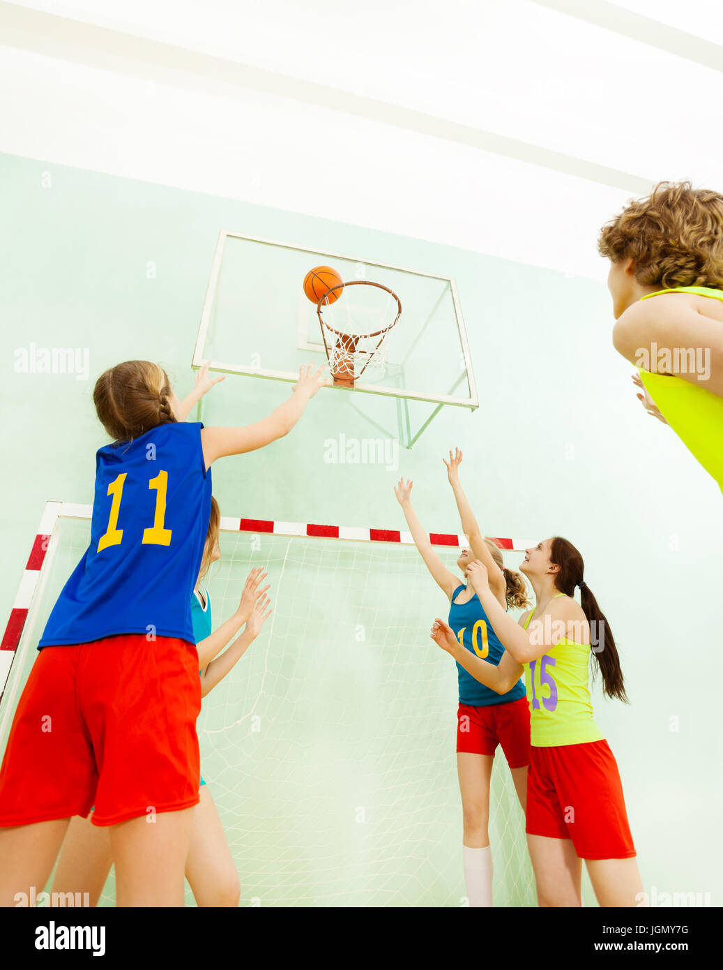 Teenagers playing basketball in sports hall Stock Photo - Alamy
