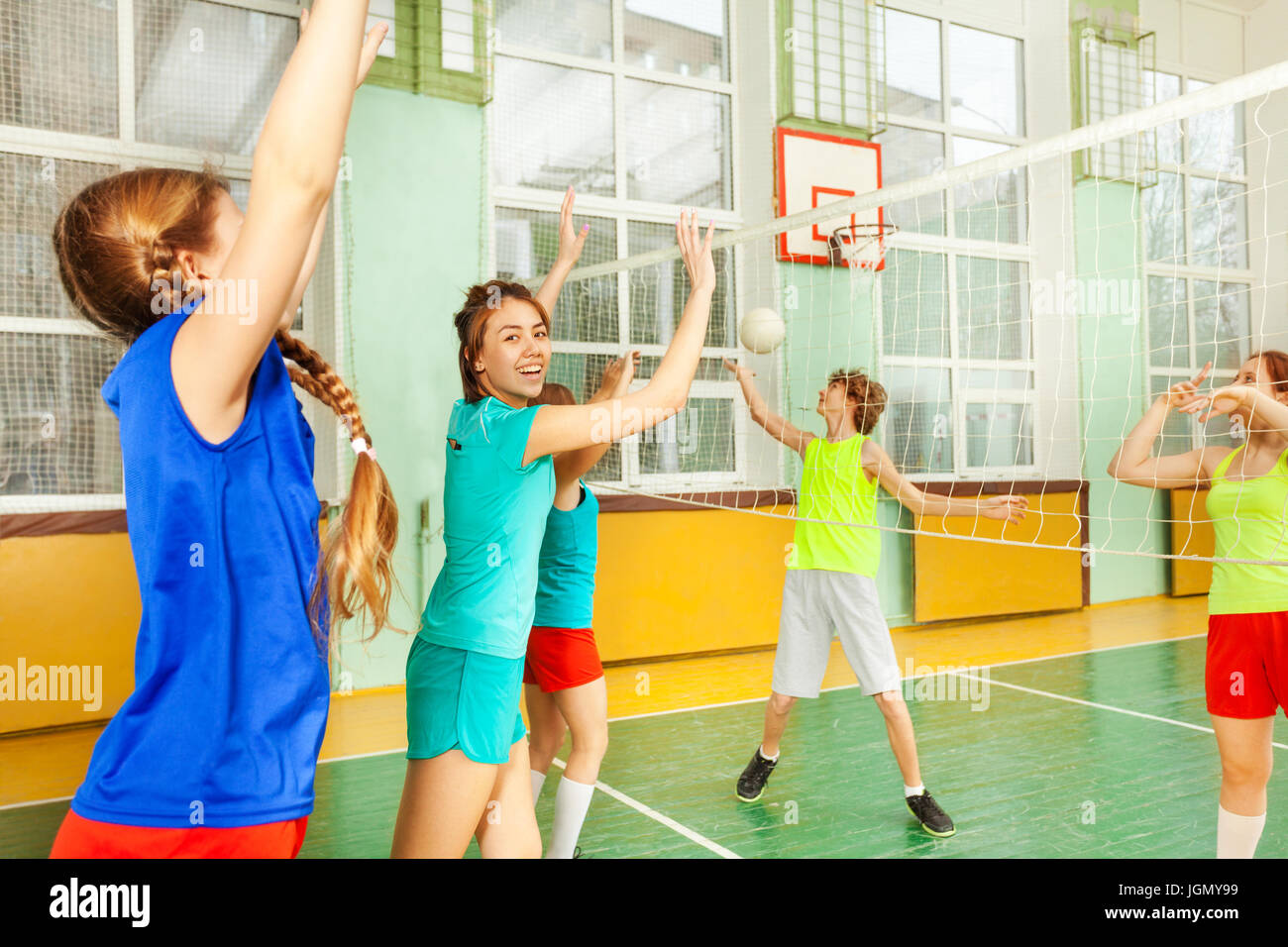 Teenage girl catching ball during volleyball match Stock Photo - Alamy