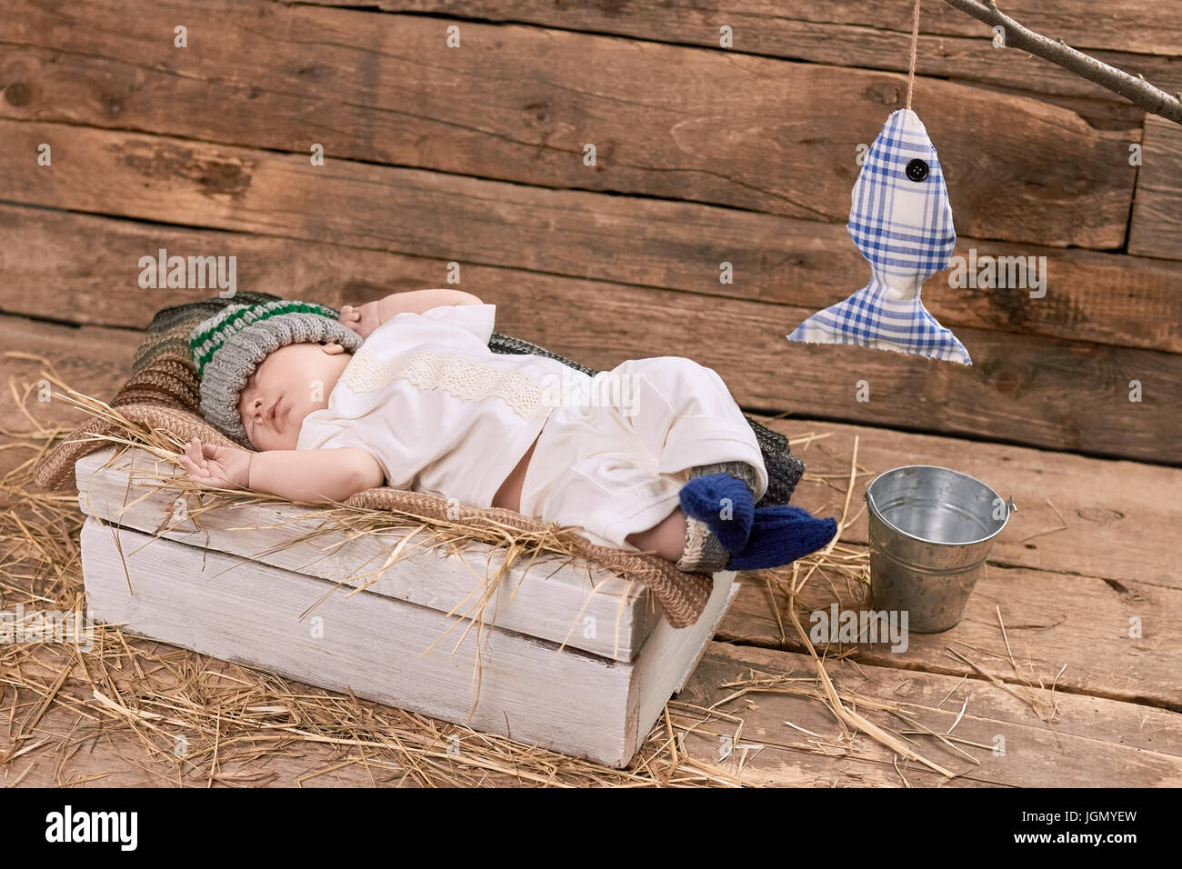 Baby fisherman sleeping. Child, wood and hay background. Tips for ...