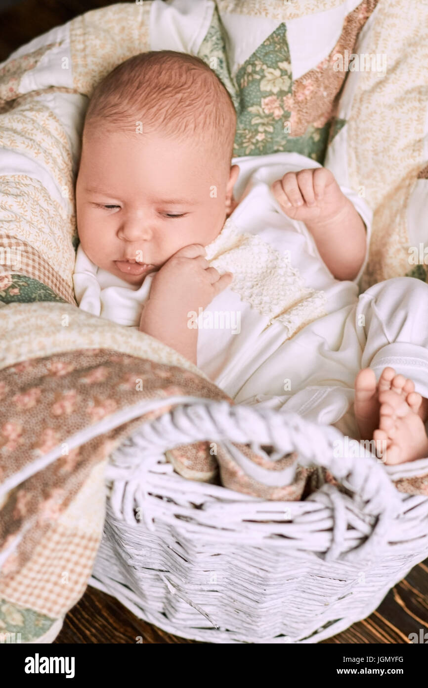 Infant boy in the basket. Cute small caucasian child Stock Photo - Alamy
