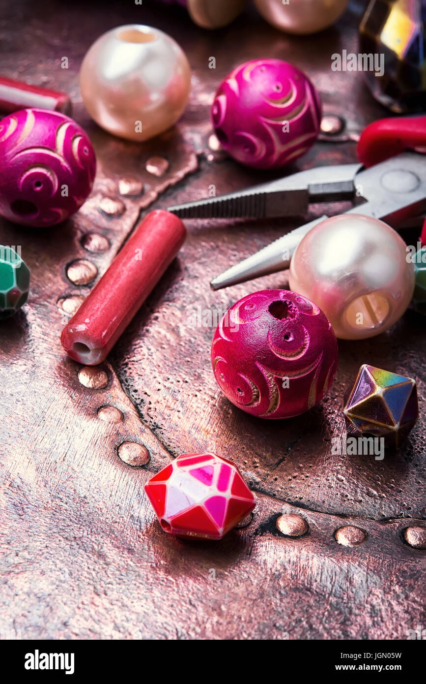 Making of handmade jewellery from colorful beads.Colorful bead heap ...