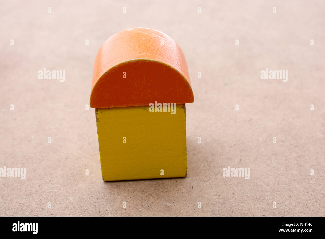 House shape formed out of building blocks on a brown background Stock ...