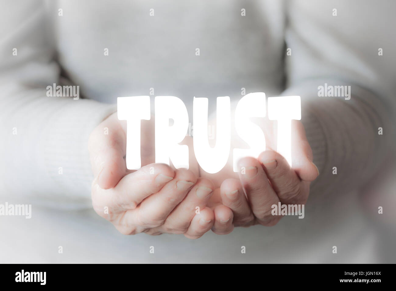 Woman's hands holding TRUST Stock Photo - Alamy