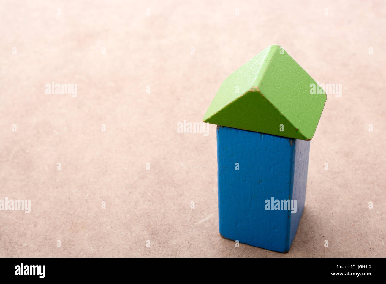 House shape formed out of building blocks on a brown background Stock ...
