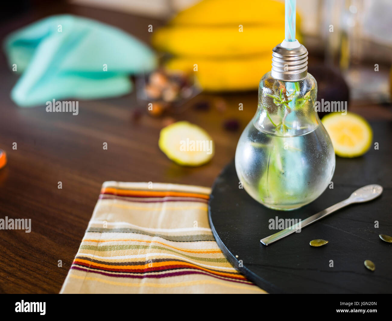 Small design jar with straw filled with infused water of lemon, straw ...
