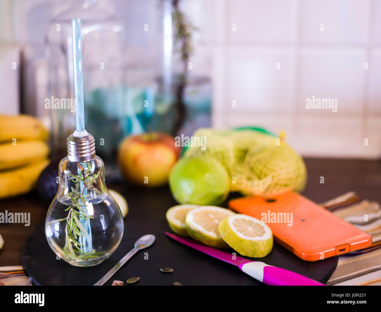 Small design jar with straw filled with infused water of lemon, straw ...