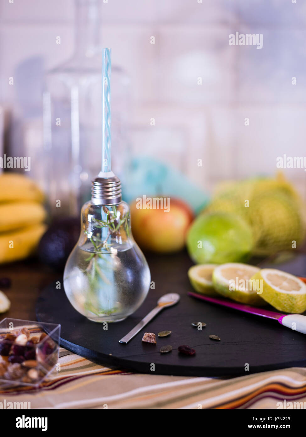Small design jar with straw filled with infused water of lemon, straw ...