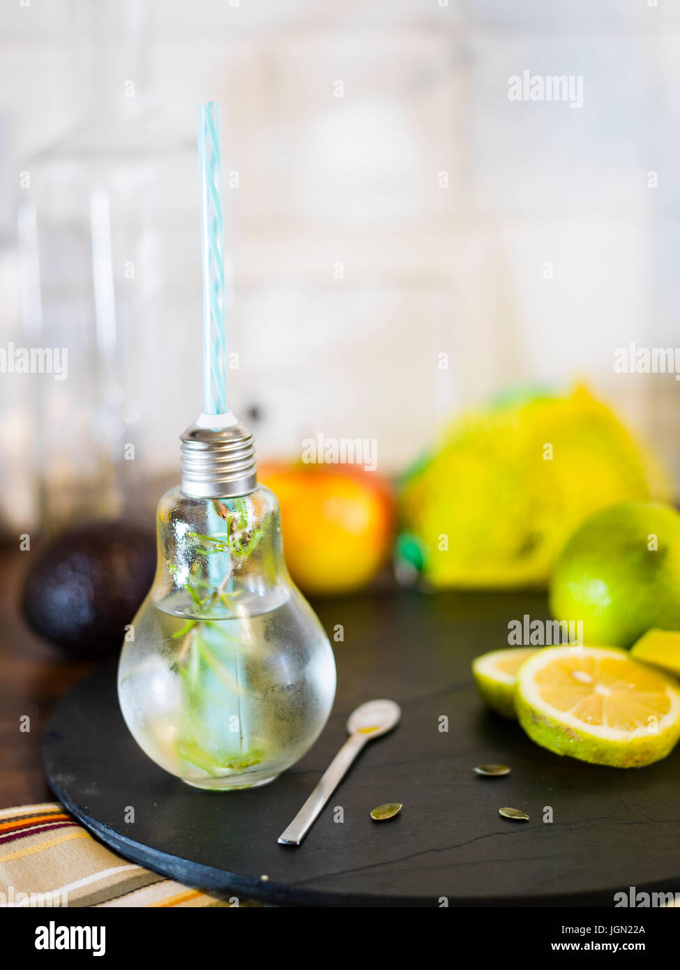 Small design jar with straw filled with infused water of lemon, straw ...