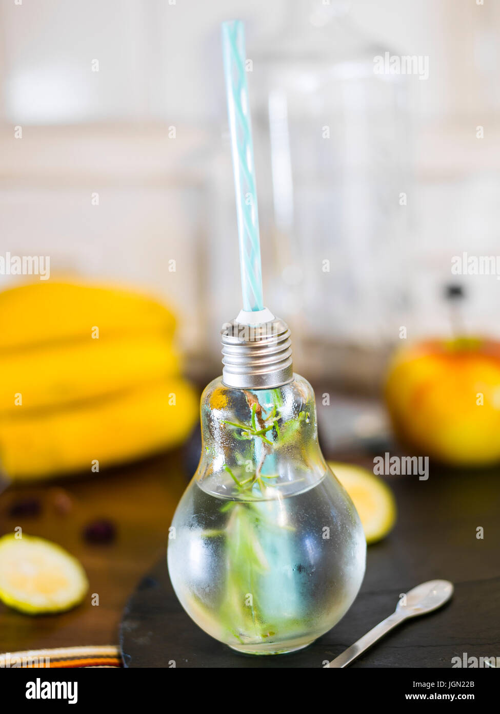 Small design jar with straw filled with infused water of lemon, straw ...