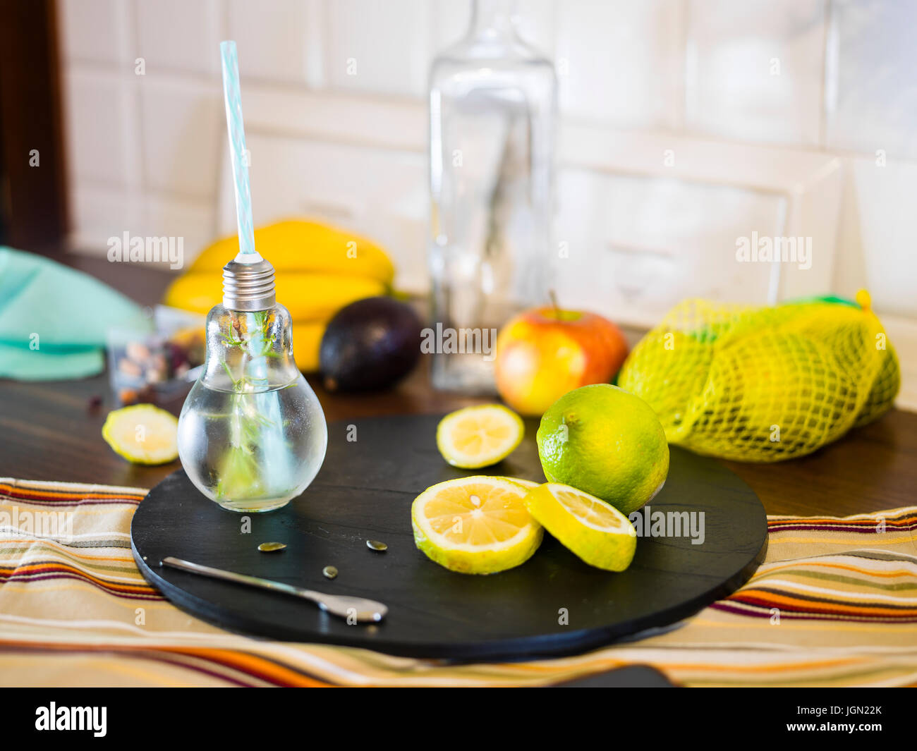 Small design jar with straw filled with infused water of lemon, straw ...