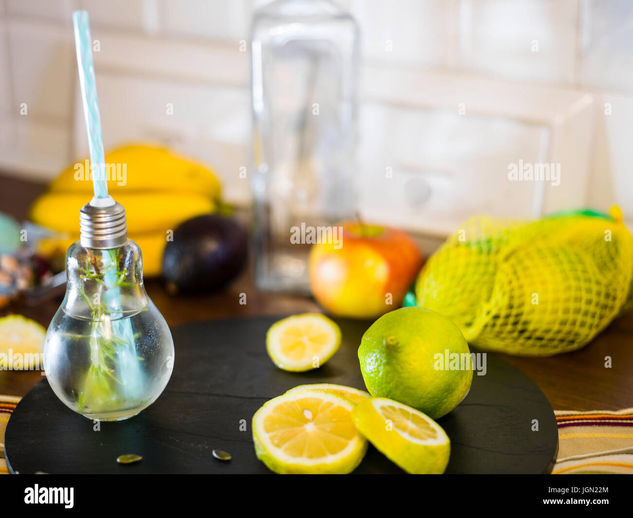 Small design jar with straw filled with infused water of lemon, straw ...