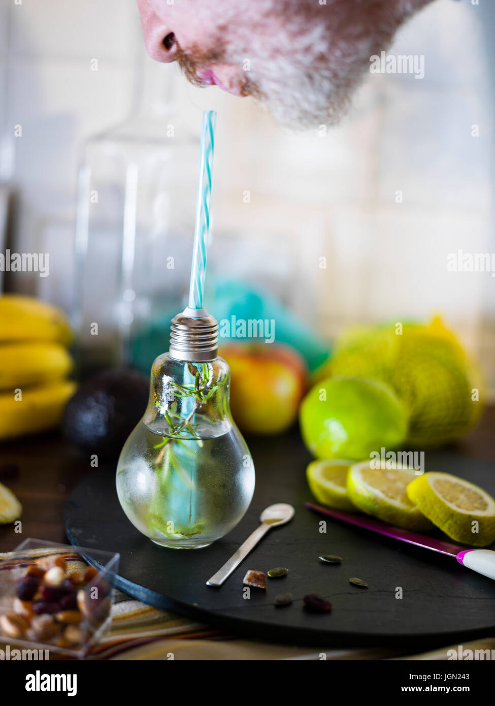 Small design jar with straw filled with infused water of lemon, straw ...