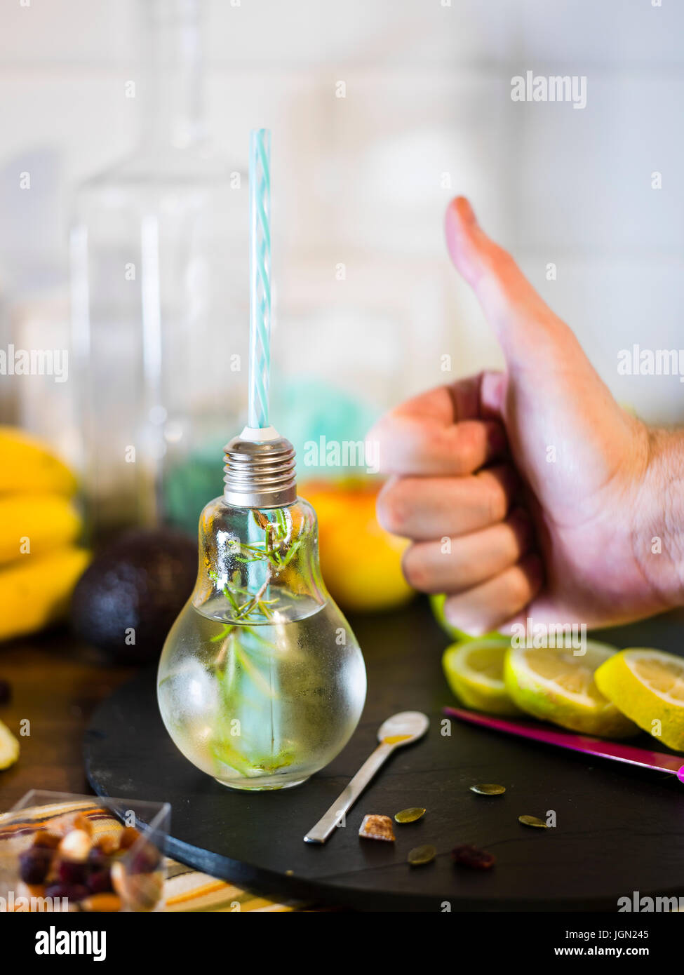 Small design jar with straw filled with infused water of lemon, straw ...