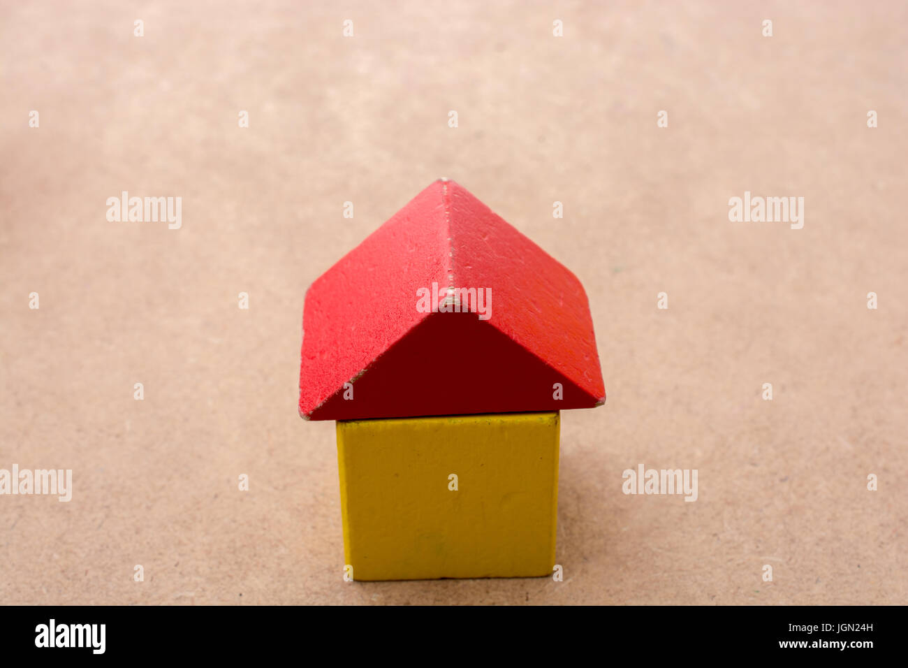 House shape formed out of building blocks on a brown background Stock ...