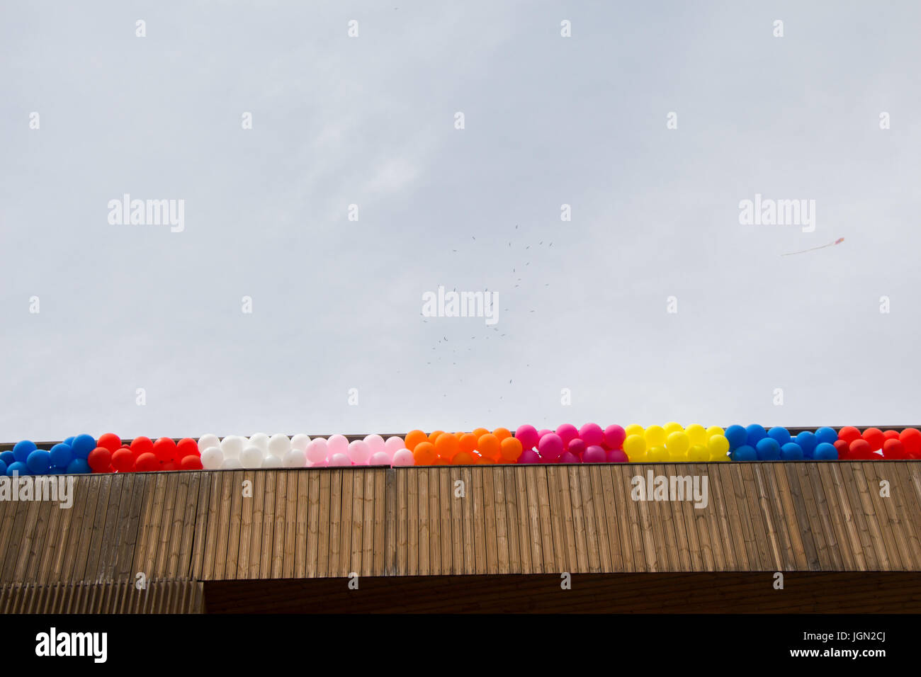 Color balloons on the roof of a building Stock Photo - Alamy