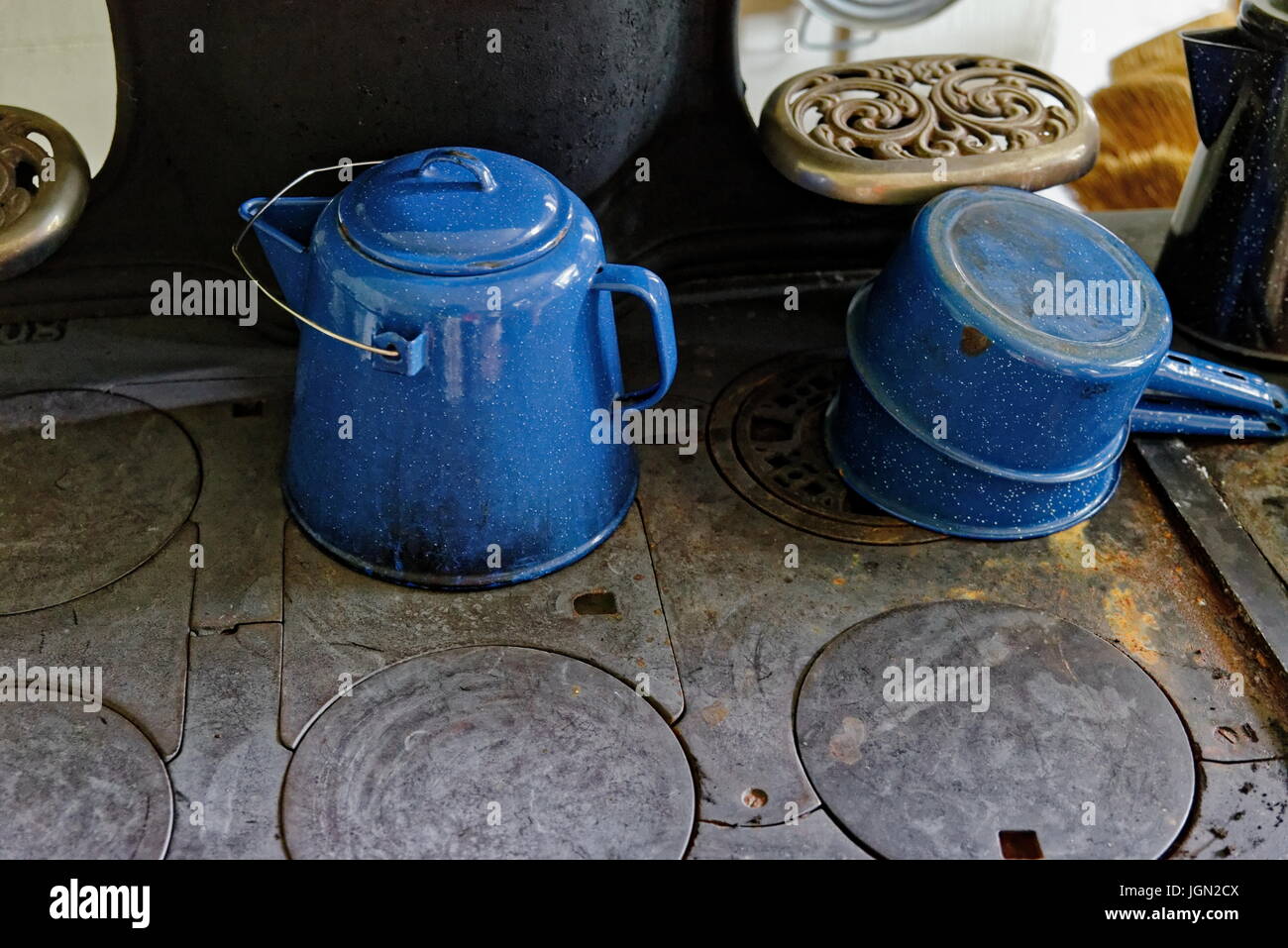 Blue pots on an antique wood burning cook stove Stock Photo - Alamy