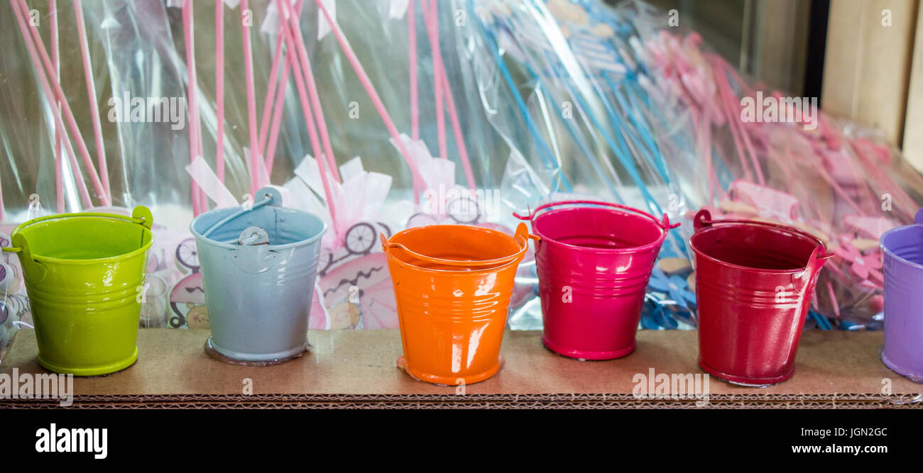 Little set of buckets of various colors in a market place Stock Photo ...