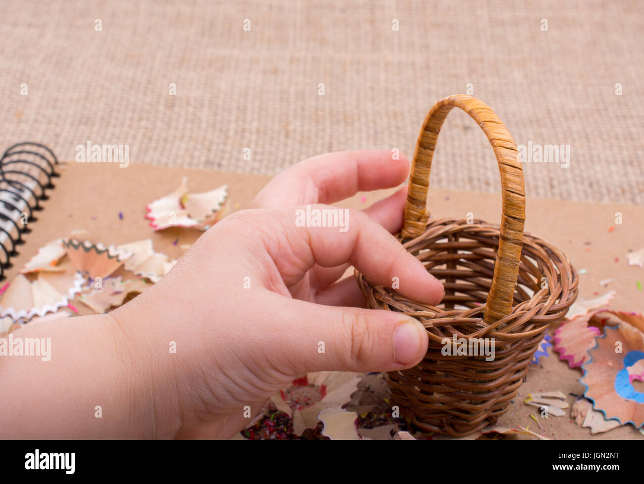 Hand holding a wicker basket on a canvas background Stock Photo - Alamy