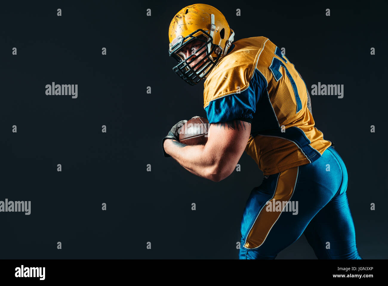 American football offensive player with ball in hand, national league ...