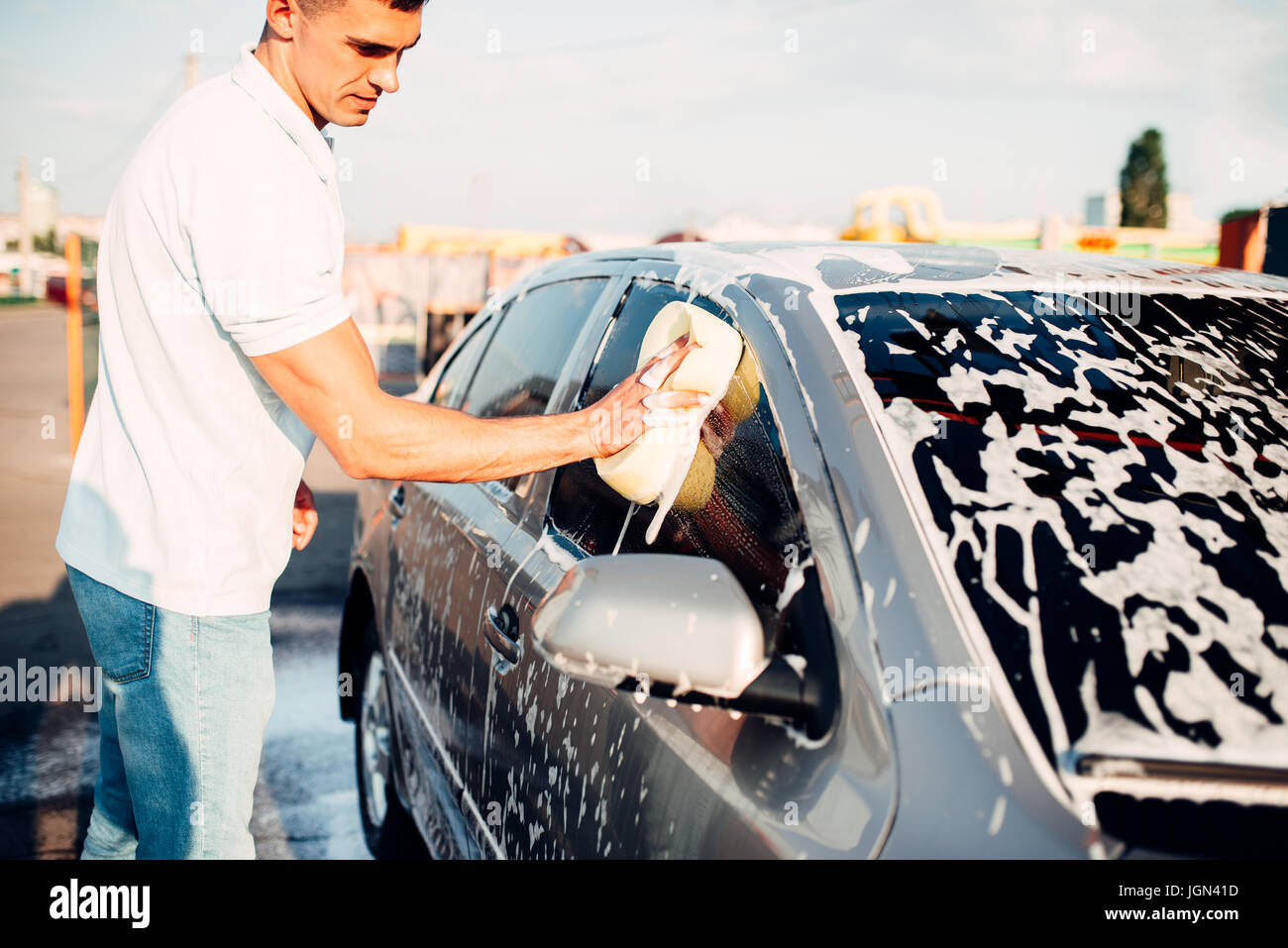 Washer rubbing vehicle with foam, automobile in suds, car wash ...