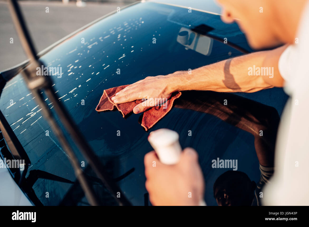 Male hand with tool for washing windows, car wash. Carwash station ...