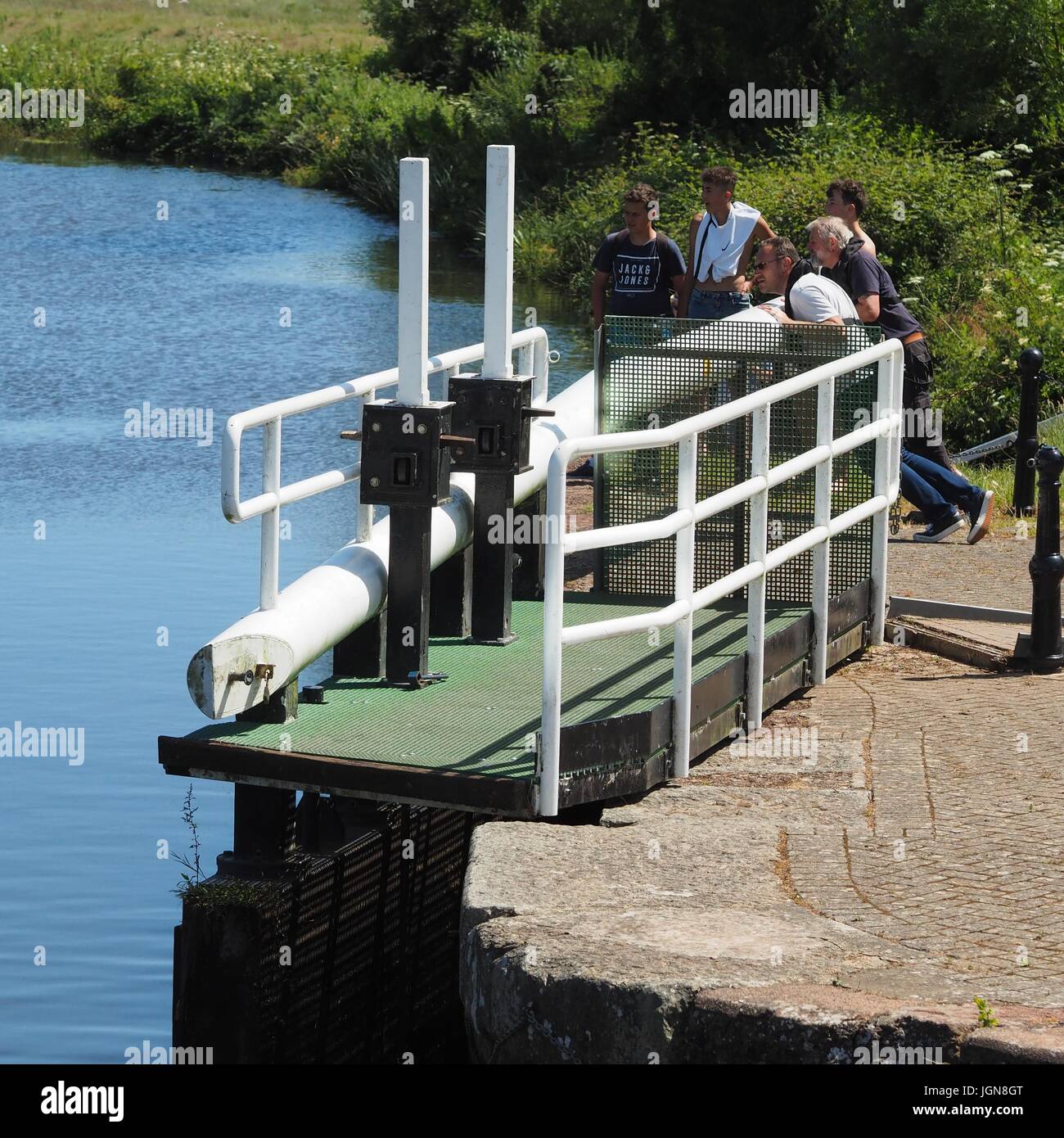 Lock attendants pushing open lock gate Stock Photo - Alamy