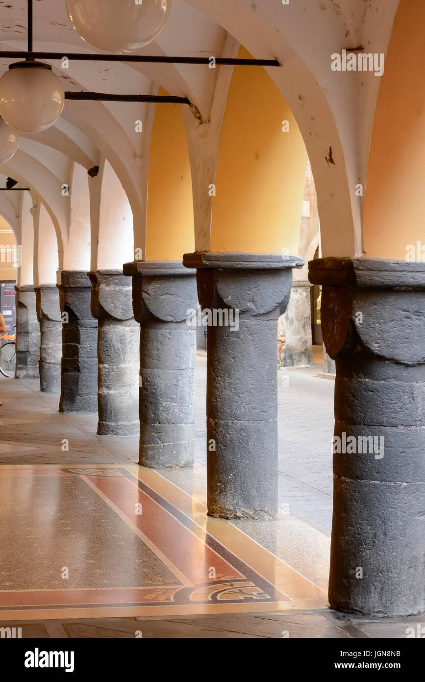 foreshortening of stone columns of old medieval arched arcade, shot at ...