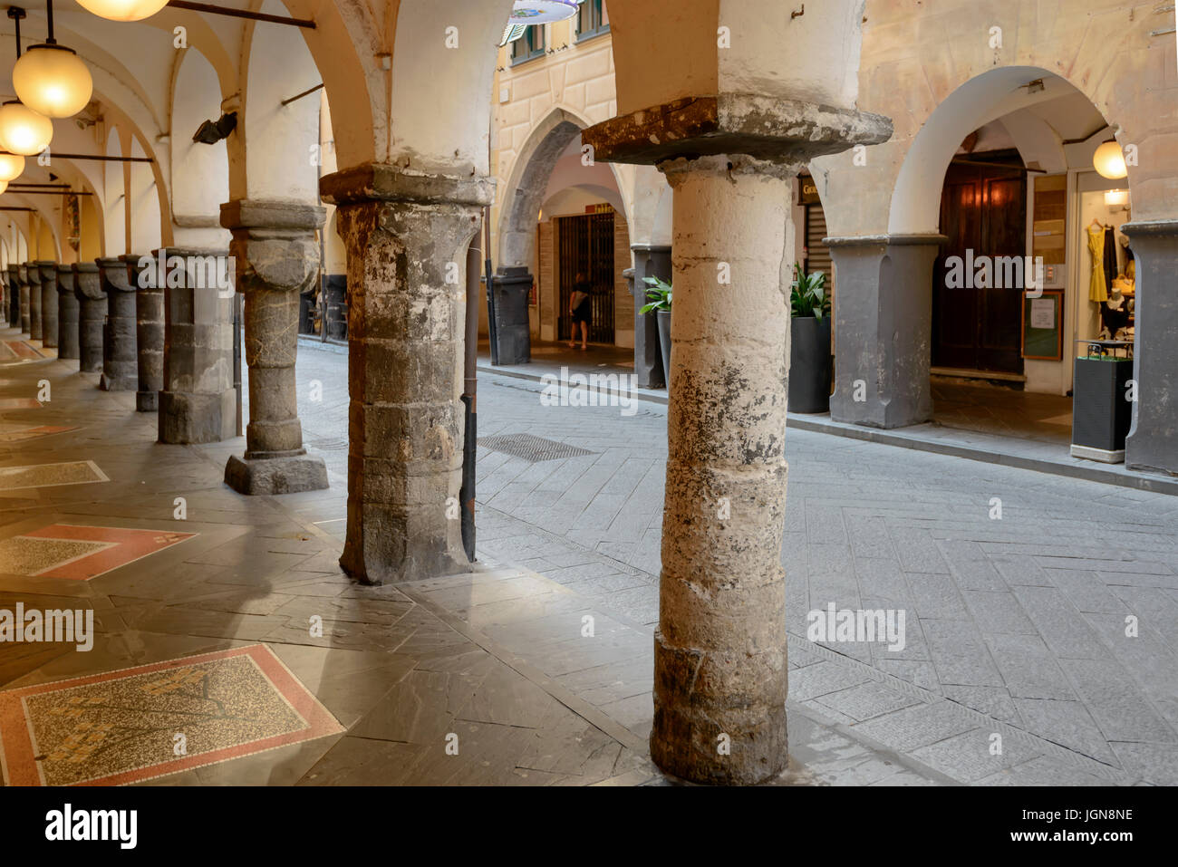 foreshortening of stone columns at old medieval covered walkway, shot ...