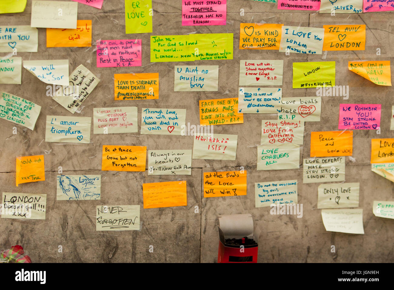 People reading and writing Post-it note tributes at London Bridge for ...