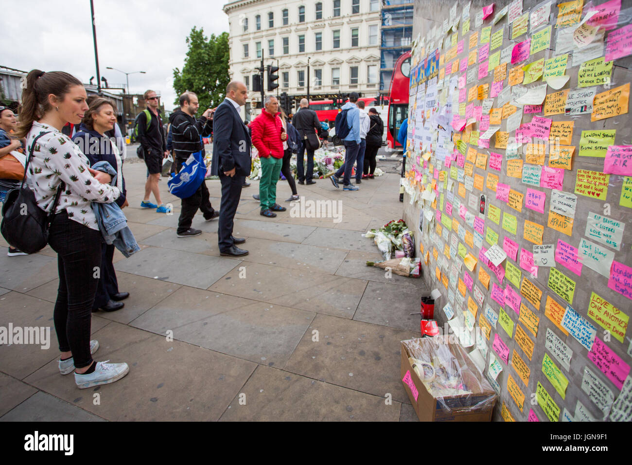 People reading and writing Post-it note tributes at London Bridge for ...