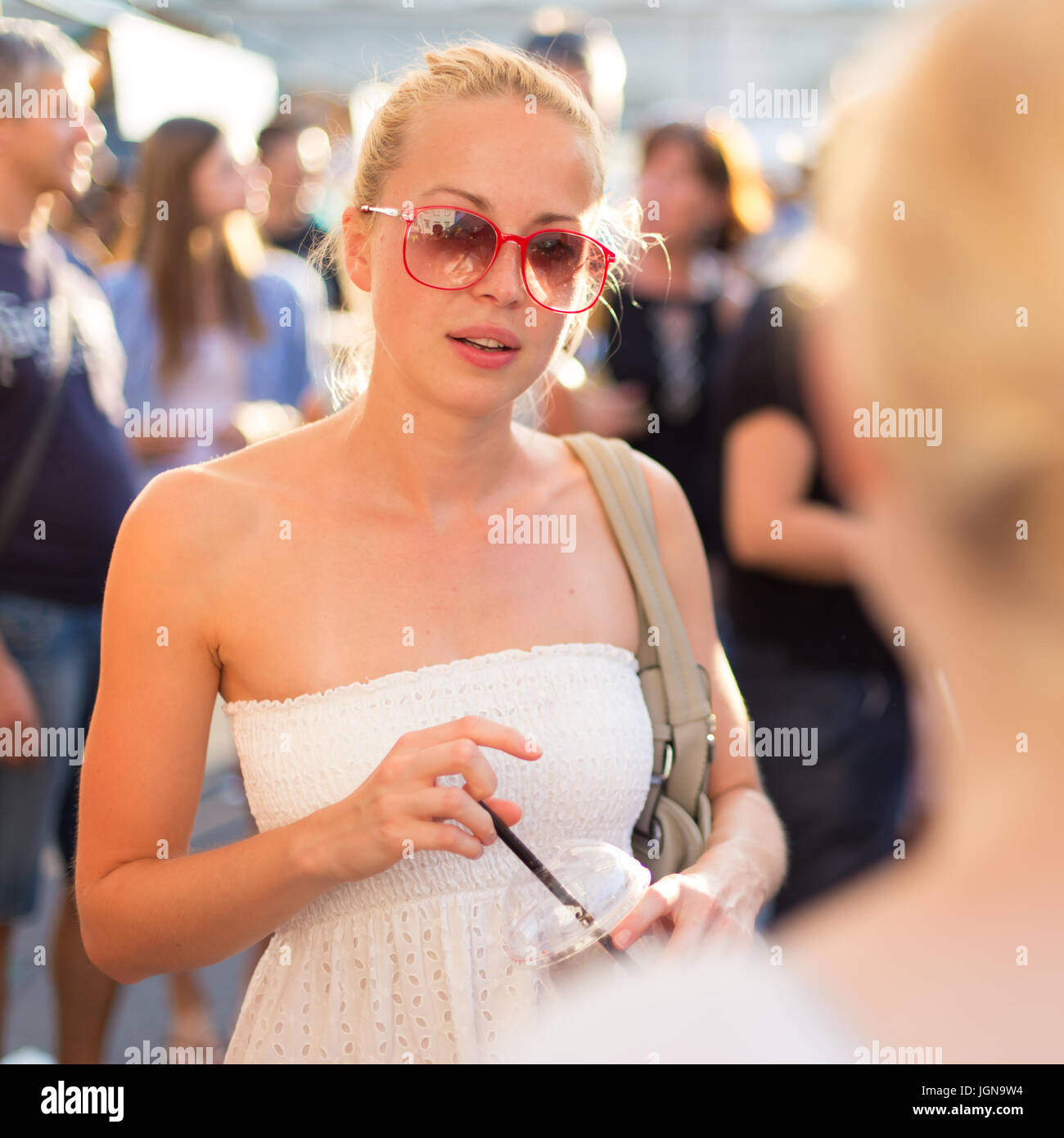 Female friends enjoying a conversation on market Stock Photo - Alamy