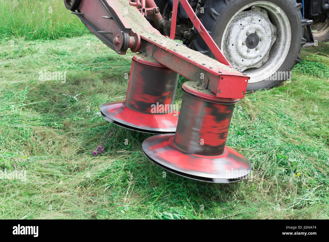 Rotating tractor mower in working position Stock Photo - Alamy