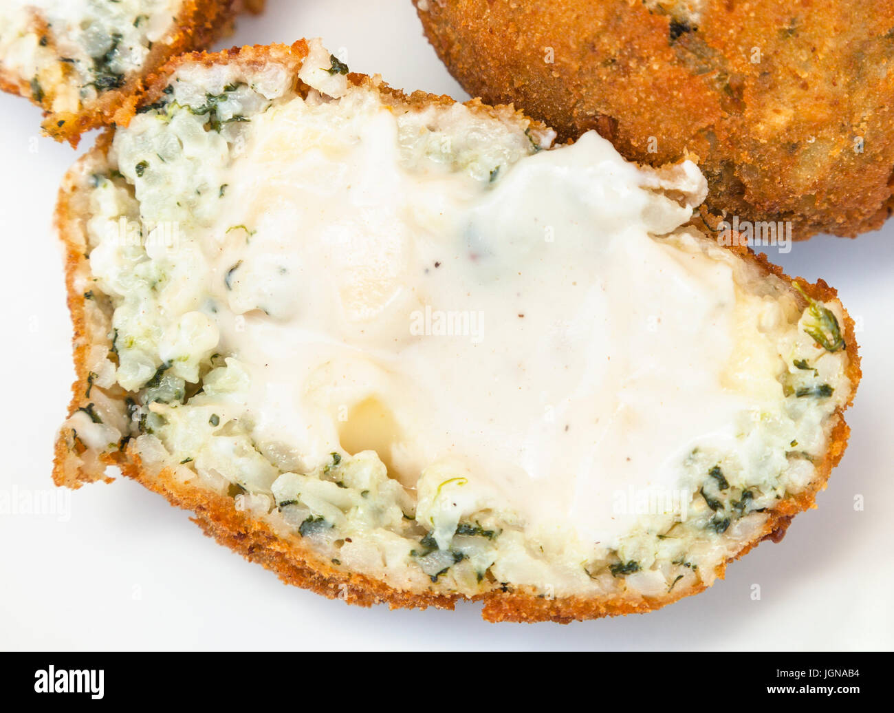 traditional sicilian street food - open spinach stuffed rice balls ...