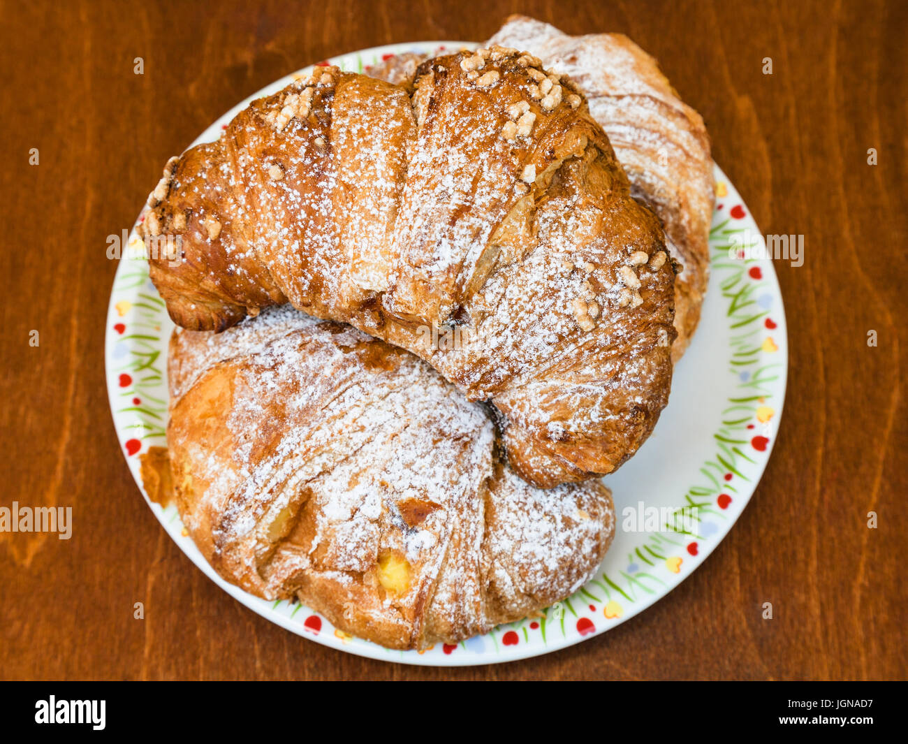 top view of three fresh italian croissants filled by vanilla and ...