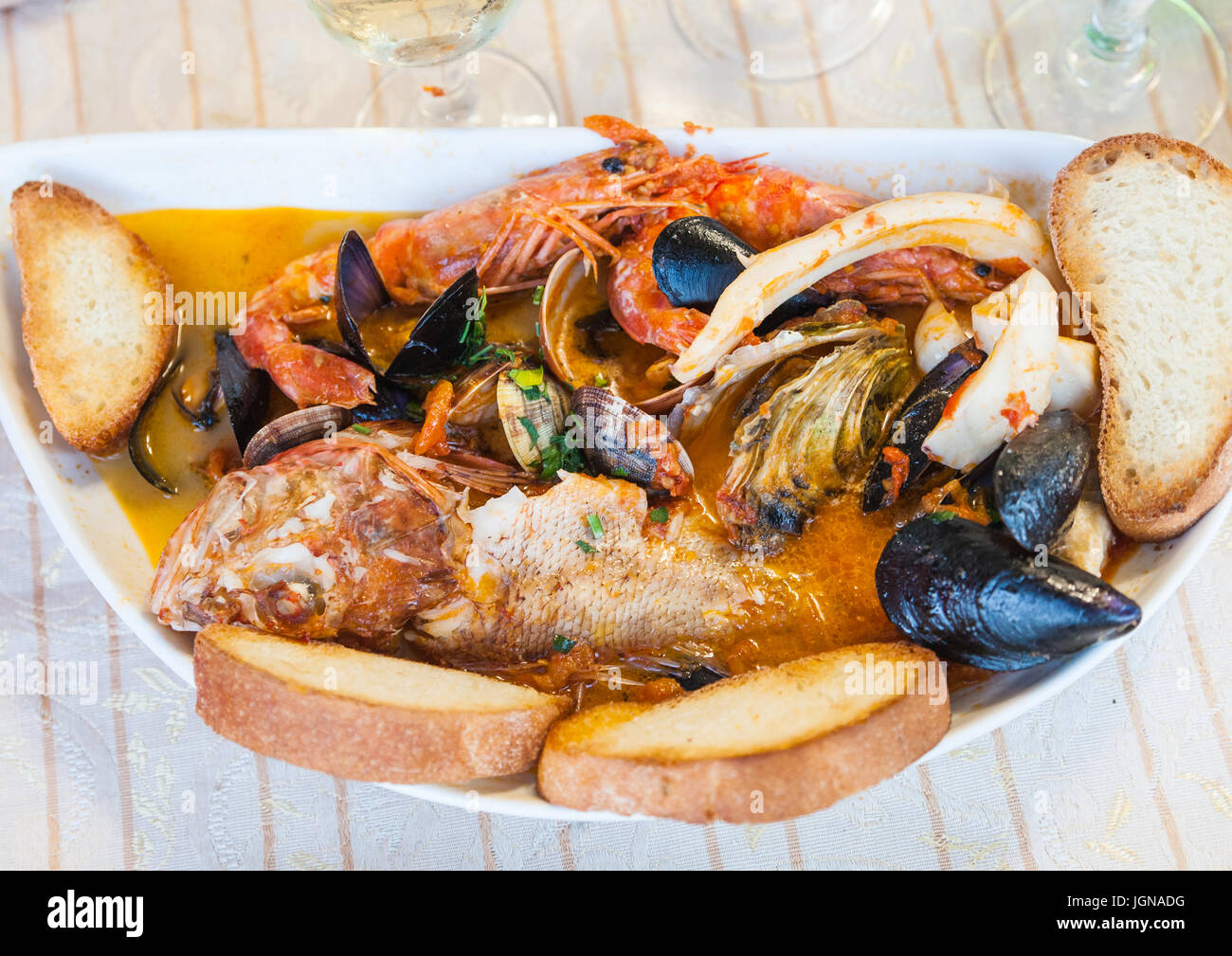 typical italian food - fish soup with seafood in sicilian restaurant ...