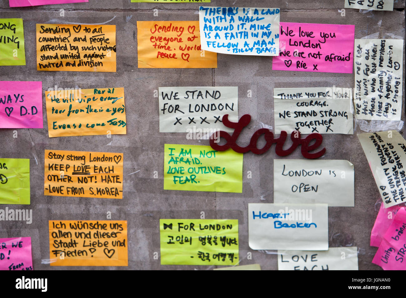People reading & writing post it note tributes at London Bridge for the ...