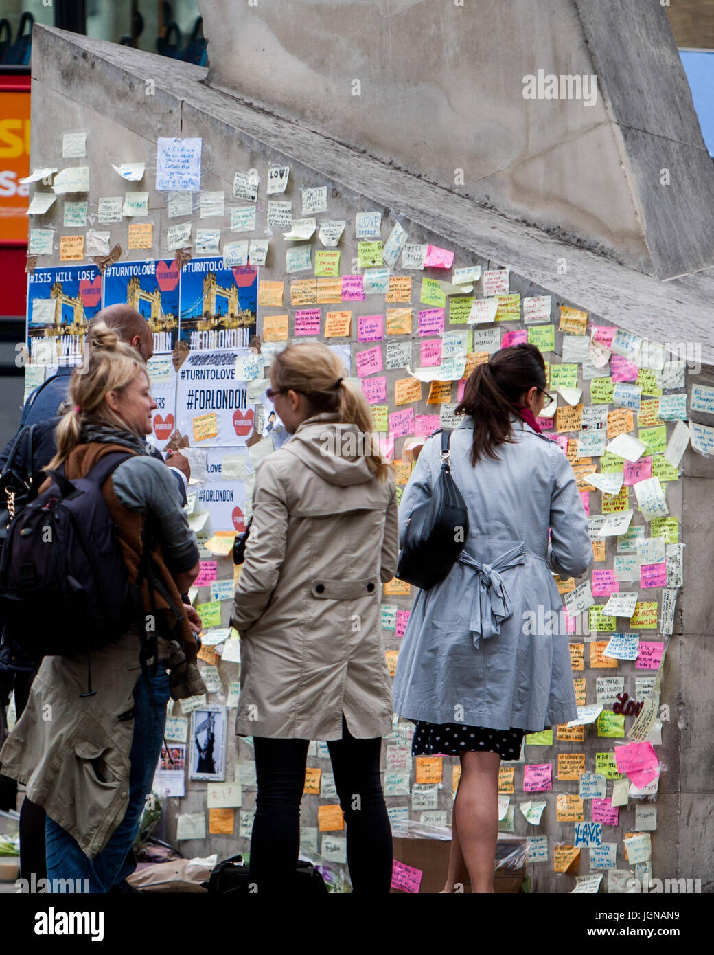 People reading & writing post it note tributes at London Bridge for the ...