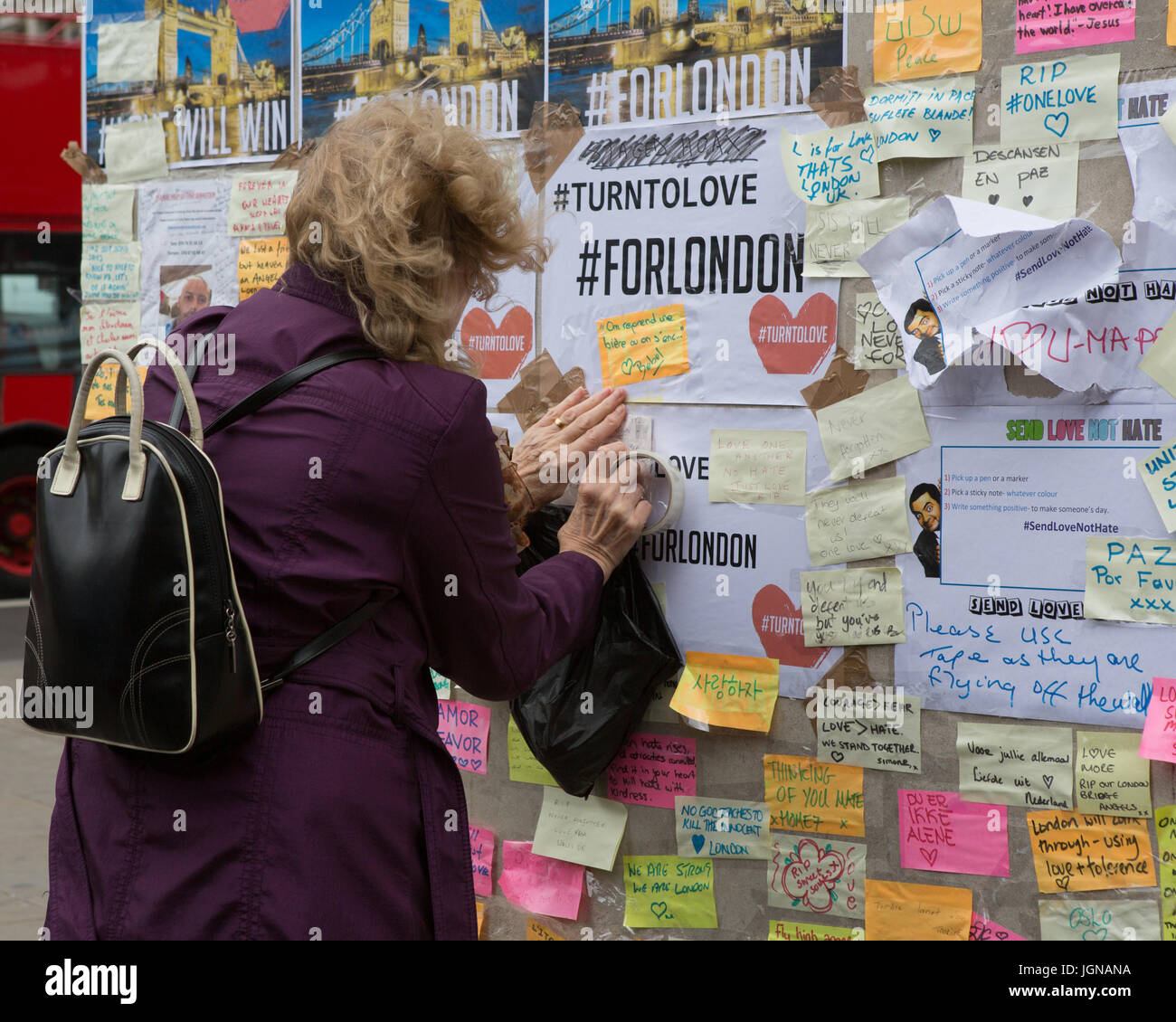 People reading & writing post it note tributes at London Bridge for the ...