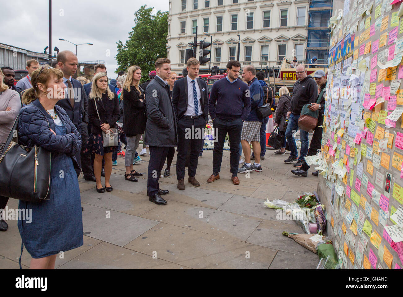 People reading & writing post it note tributes at London Bridge for the ...