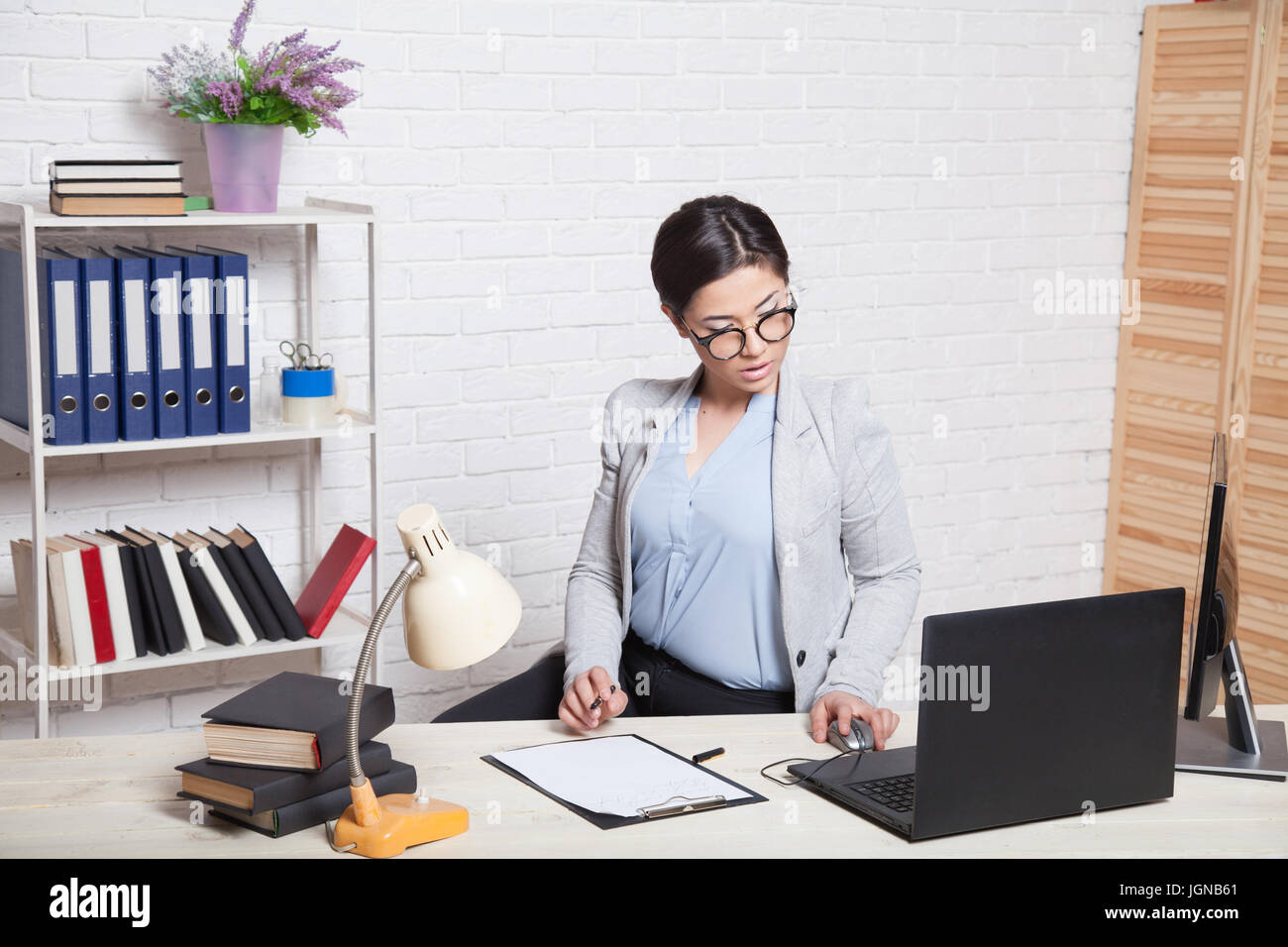 business girl sits at a computer in the Office paper folders Stock ...