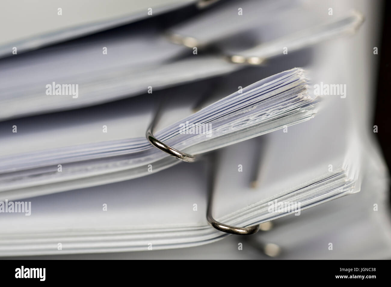 Silver paper clips on paper work macro shot Stock Photo - Alamy