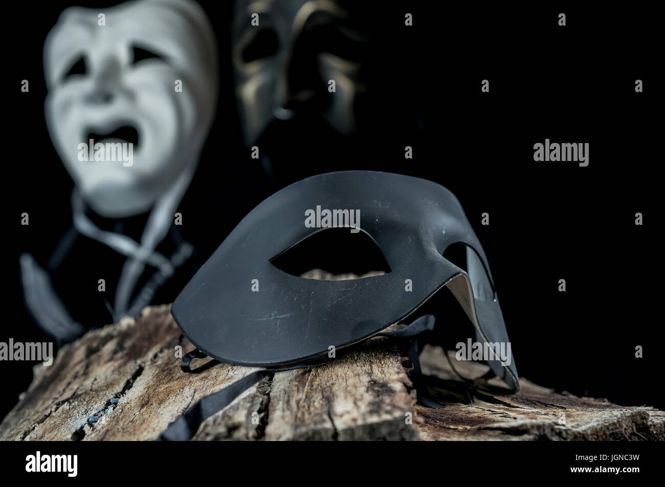 Black theatrical mask with more on the background Stock Photo - Alamy