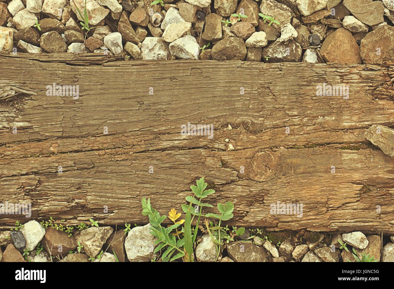 piece of wood lying on a gravel background Stock Photo - Alamy