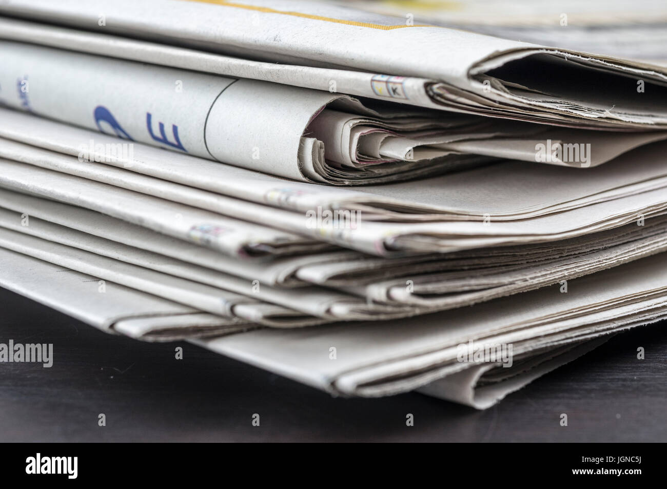 Close up shot of a pile of newspapers Stock Photo - Alamy